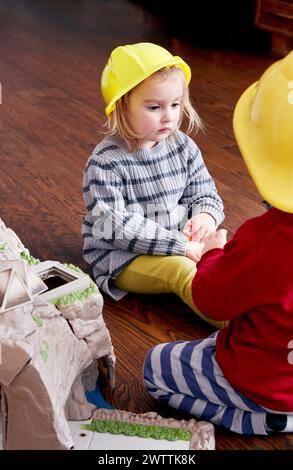 Child in red hat playing in snow on Christmas vacation. Winter outdoor ...