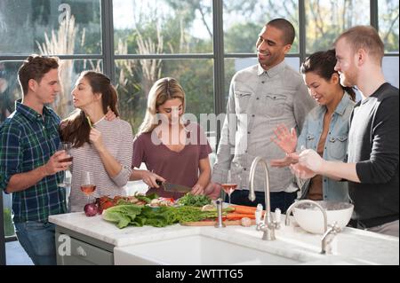 Friends cooking together in kitchen Stock Photo - Alamy