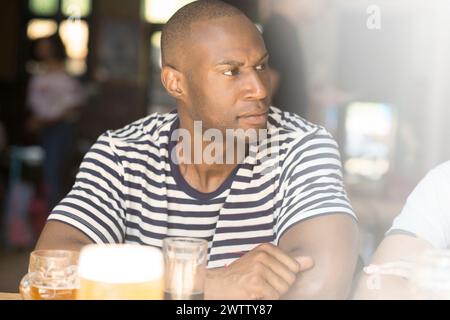 Adult man in striped t-shirt screaming and rubbing temples because of ...