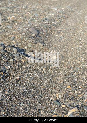 Rut in the sand. Tracks from car wheels on the beach. Sand and stones ...