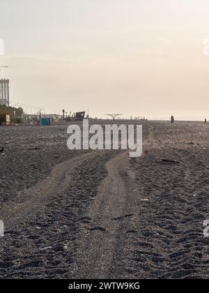 Rut in the sand. Tracks from car wheels on the beach. Sand and stones ...