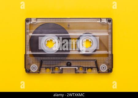 Transparent cassette tape with visible inner parts on white background ...