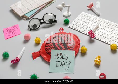 Computer keyboard with whoopee cushion, funny glasses and sticky notes ...