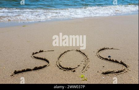 The inscription on the sand at the beach sos Stock Photo - Alamy