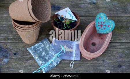 Planting pots made of clay or cardboard. A shovel, seed bags, a heart ...