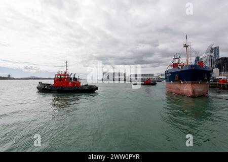 Two tug boats assist the Cargo ship Rangitata to get off the dock at ...