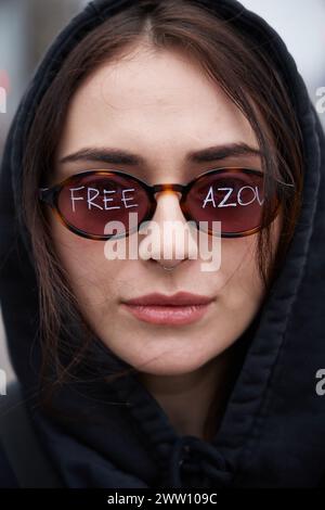 Portrait of Ukrainian activist wearing sunglasses with a writing "Free ...