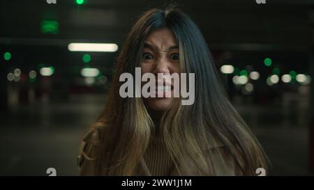 Mad angry crazy Asian korean chinese japanese girl shout in car parking ...