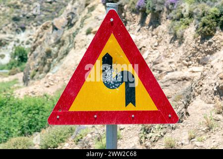 A trafic sign aside a road with traces of bullets in middle on the ...