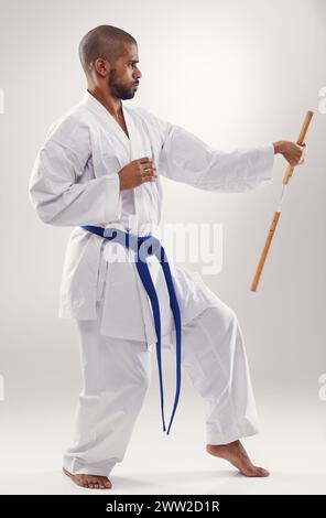 Nunchucks, karate and man in martial arts fight with weapon in training ...