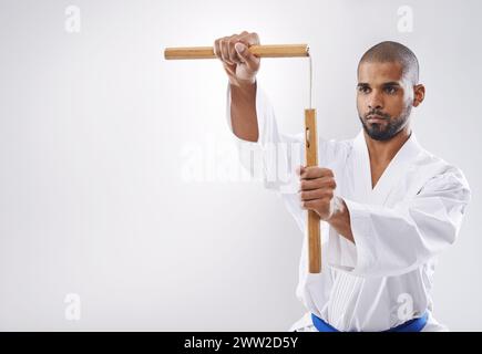 Nunchucks, karate and man in martial arts fight with weapon in training ...