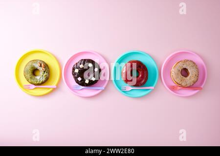 Four colorful plates with donuts on them Stock Photo - Alamy