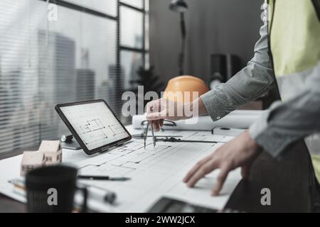 Architect using divider compass working on blueprint. House planning ...