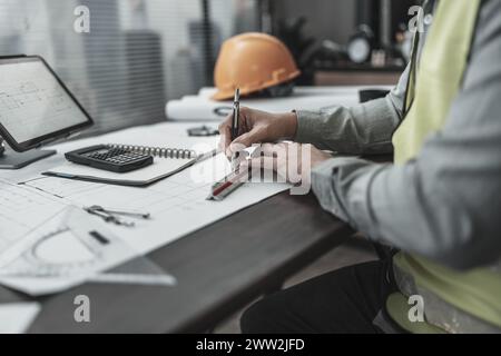 Engineering working with drawings inspection and writing on the office ...