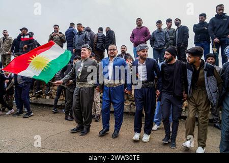 Akre, Iraq. 20th Mar, 2024. An Iraqi Kurdish man carries a fire torch ...