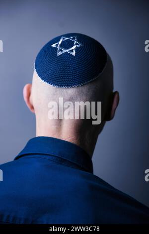 Jewish man wearing a kippa with a Star of David on his head, back view ...
