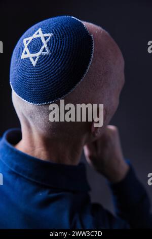 Jewish man wearing a kippa with a Star of David on his head, back view ...