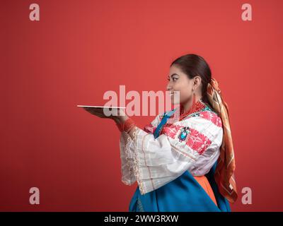 Brunette hispanic girl holding red heart serious face thinking about ...