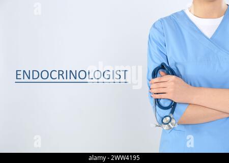 Endocrinologist with stethoscope on light grey background, closeup ...