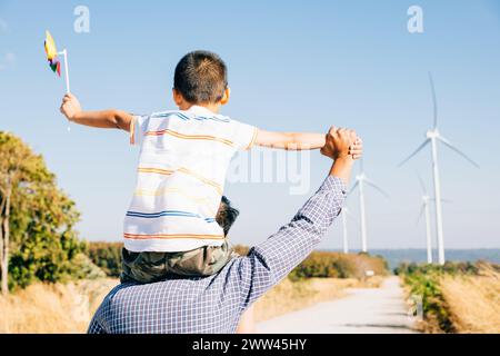 Father holds daughter with pinwheel enjoying Stock Photo - Alamy