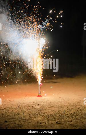 The small fountain of lit firecrackers releasing colored ignited ...