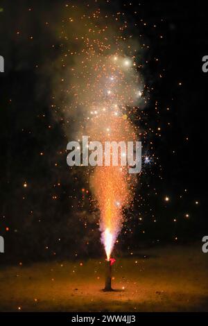 The small fountain of lit firecrackers releasing colored ignited ...