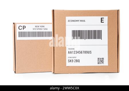 Cardboard packages with shipping labels and barcodes on white ...