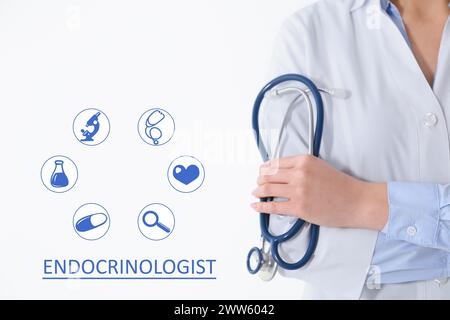 Endocrinologist with stethoscope and different icons on white ...