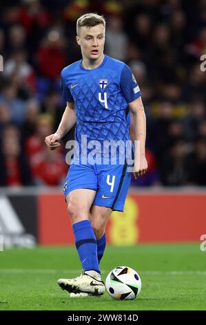 Cardiff, UK. 21st Mar, 2024. Aaron Ramsey of Wales takes a look at th ...