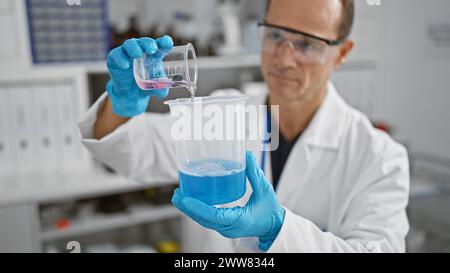 Middle age man scientist measuring liquid at laboratory Stock Photo - Alamy