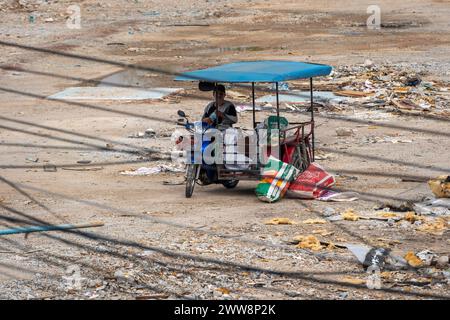 A saleng (Thai three-wheel motorcycle) with bags to collect garbage is ...