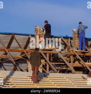 Villagers working together to build a house rooftop Stock Photo - Alamy