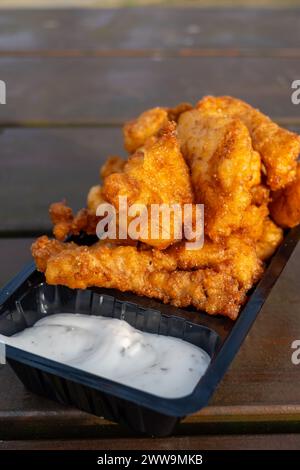 Seafood, outdoor eating of diep-fried cod fish pieces served with ...