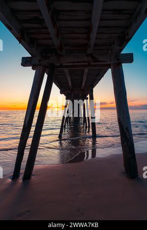 Port Noarlunga jetty with people viewed towards the beach at sunset ...
