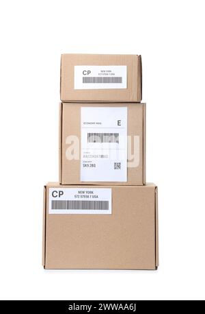 Cardboard packages with shipping labels and barcodes on white ...