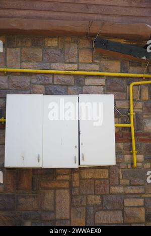 Two electrical boxes with lightning bolt on brick wall Stock Photo - Alamy