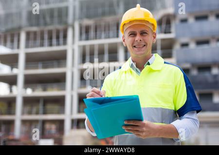 Young civil engineer makes important work notes Stock Photo - Alamy