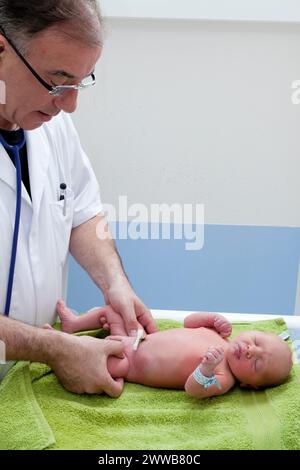The pediatrician checks the pulses of the femoral arteries Stock Photo ...