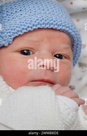 Newborn face (5 days old) awake with bonnet Stock Photo - Alamy