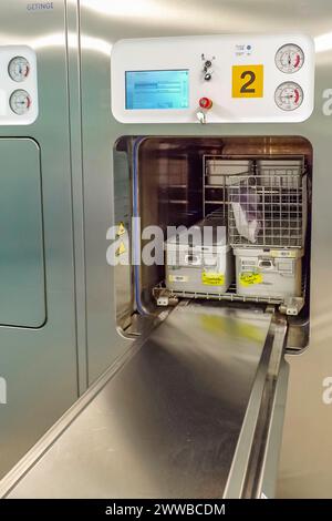 Operator with ancillary cart in front of the autoclave sterilizer Stock ...