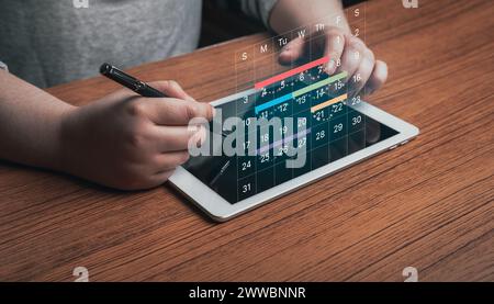 Woman use digital tablet to mark dates on virtual hologram calendar ...