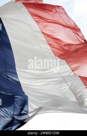 Flag of France waving in the breeze sky background Stock Photo - Alamy