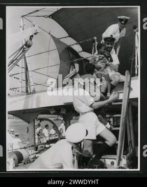 Description: Some of the orphans being assisted on board by members of ...