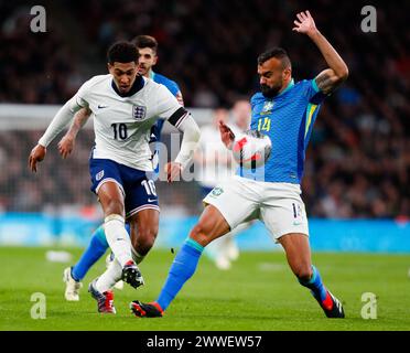 Jude Bellingham of England under pressure from Filip Kostic of Serbia ...