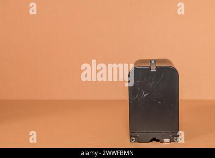 Closeup side view of used Lithium-ion battery on brown background Stock ...