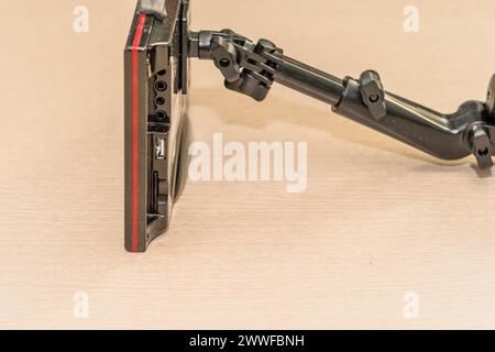 Side view of automobile navigation system with attached mounting arm ...