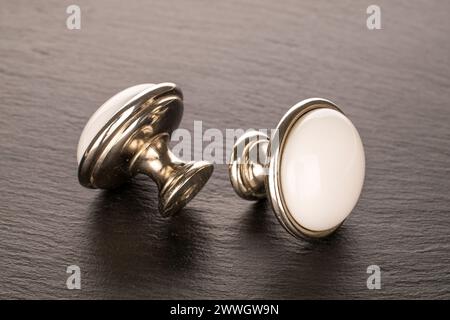 Two metal drawer handles on slate stone, furniture accessories, macro ...