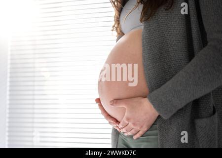 Description: Lateral view of midsection of unrecognizable woman gently ...