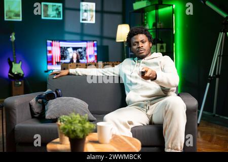 Man zapping through channels, watching news broadcast, isolated over ...