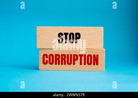 Stop corruption words written on pink torn paper with yellow background ...